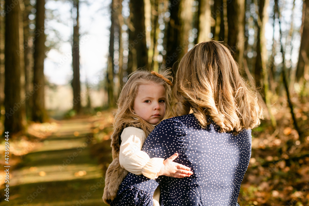 Young Girl Looking over Her Mother's Shoulder Stock Photo | Adobe Stock