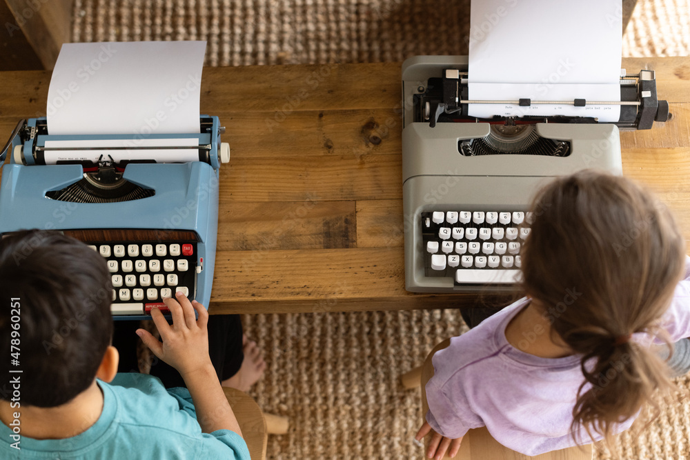 Kids typing on typewriters Stock Photo | Adobe Stock