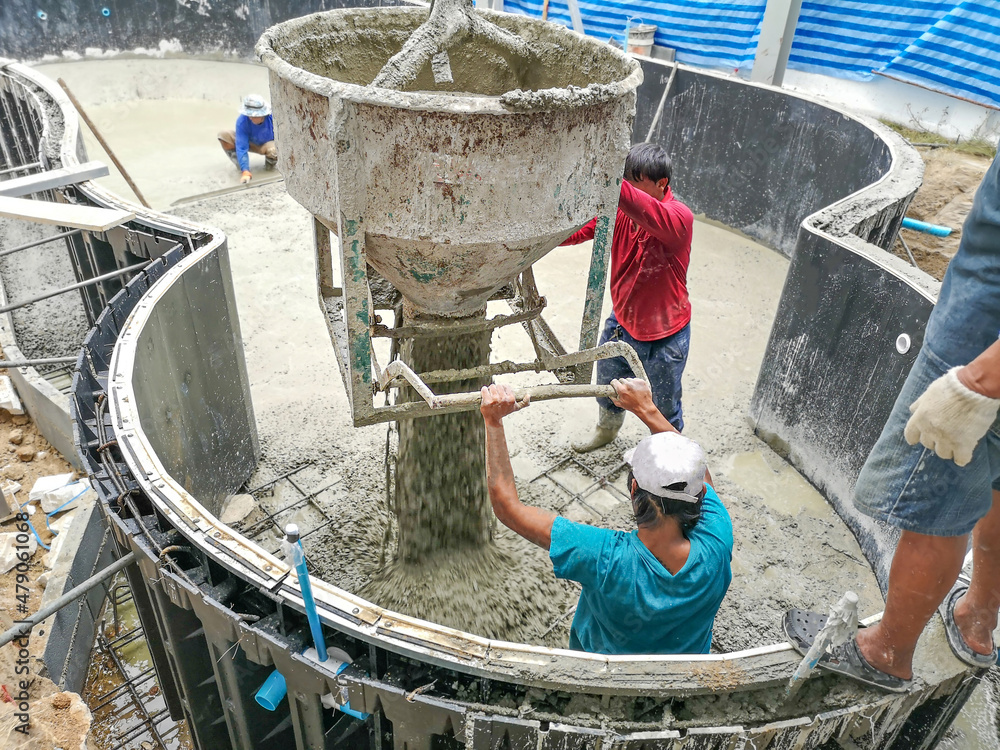 Swimming pool construction. Workers were pouring concrete work ...