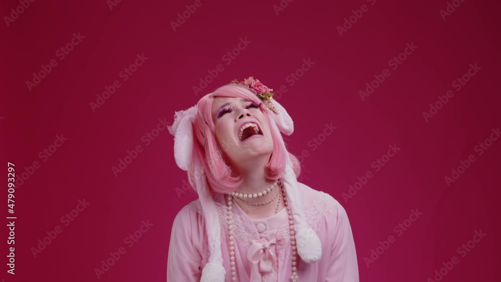 Pink sad cute candy girl with plush rabbit ears is crying, handsome guy ...