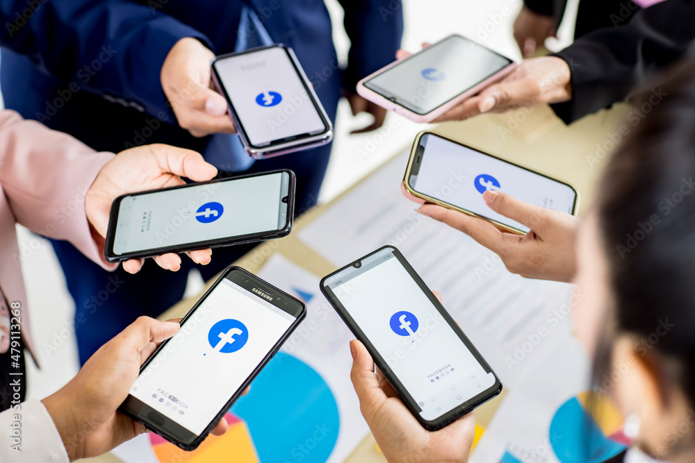 Bangkok/Thailand - August 06, 2021: People hold smartphones in ...