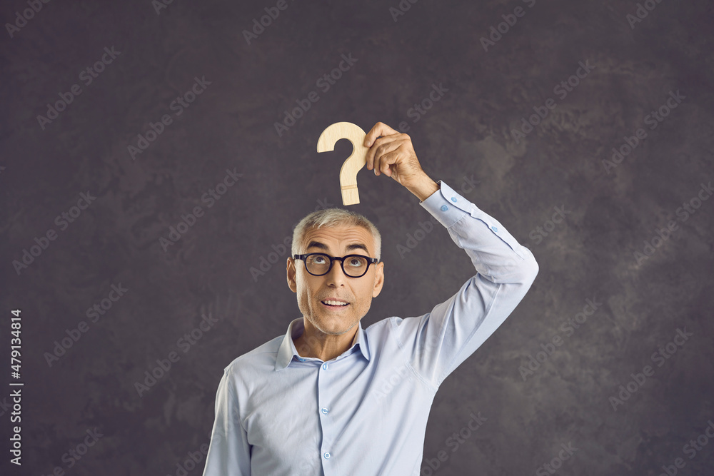 Studio portrait of curious intelligent old senior man looking at ...