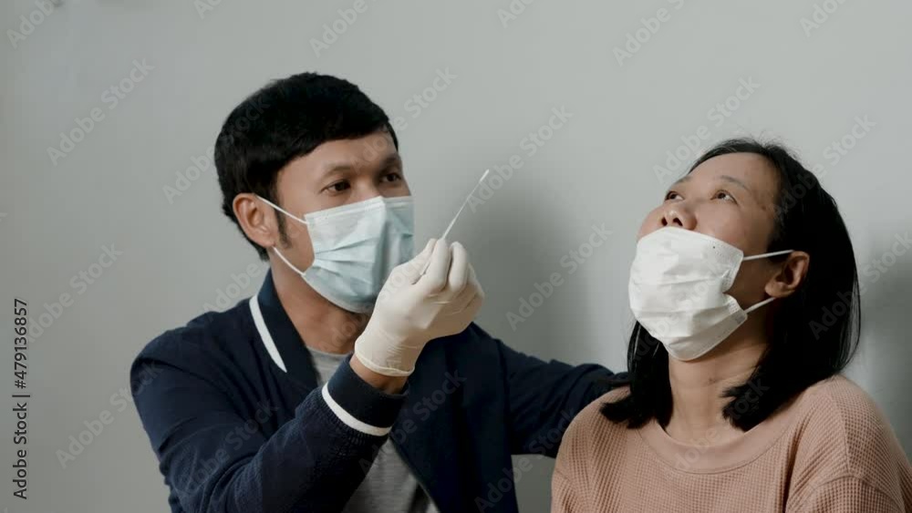 4K, Asian couple uses a rapid antigen test kit to self-test the COVID ...