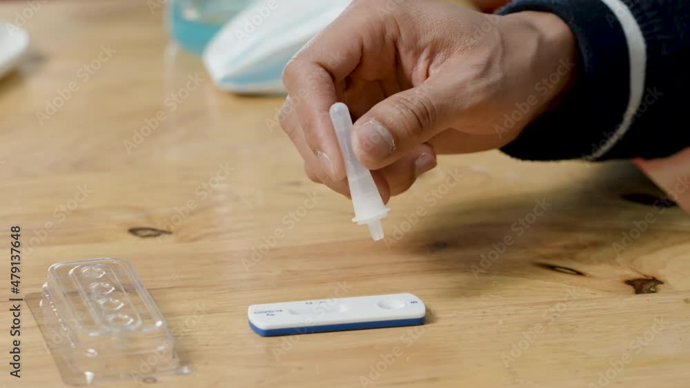 4K, Close Up Asian man's hands dropping fluid on COVID-19 specimen test ...
