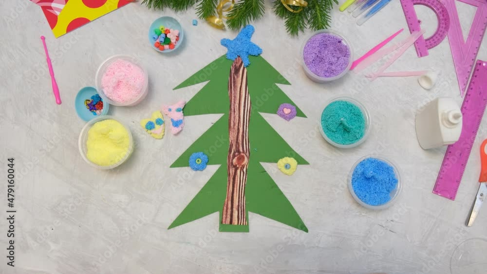 Child makes a greeting card Christmas paper and foam plasticine craft ...