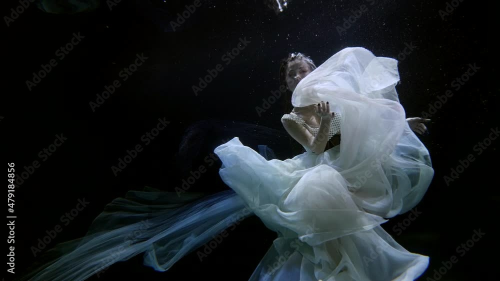 Video Stock magic mermaid is floating in darkness and depth of ocean ...