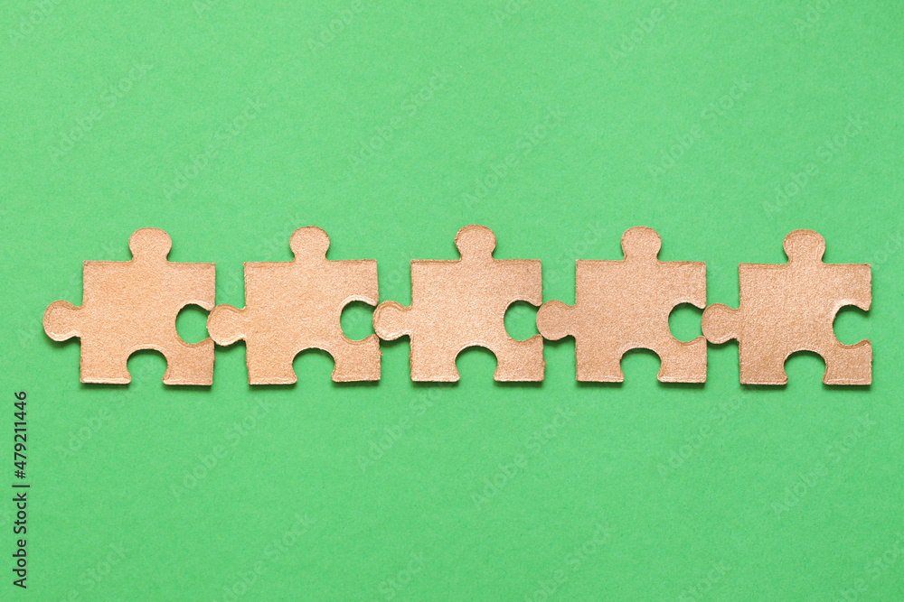 Puzzle on green background. Teamwork, Solving and completing the task ... Puzzle on green background. Teamwork, Solving and completing the task ...