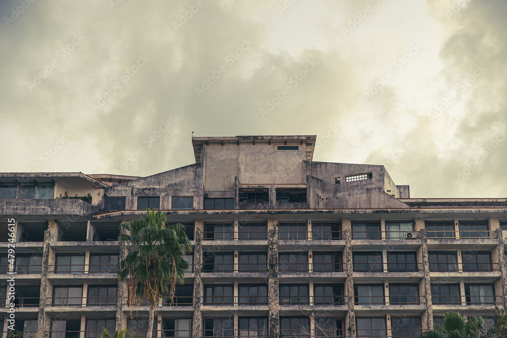 An abandoned and empty resort hotel on a tropical island beach shows ...