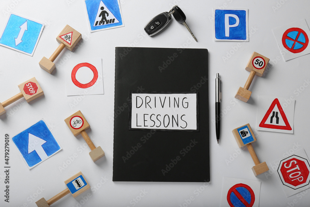 Composition with workbook for driving lessons on white background, top ...