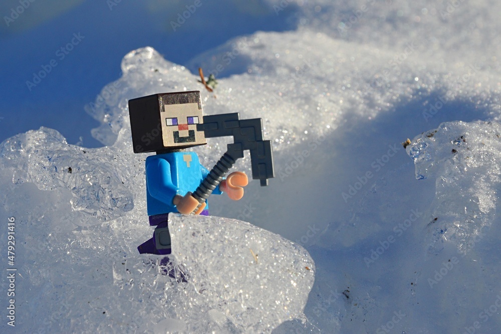 LEGO Minecraft figure of steve with iron pickaxe walking on real ...