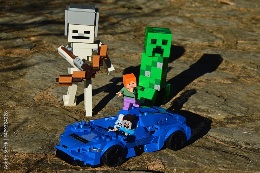 LEGO Minecraft figures of Steve and Alex escaping from giant Creeper ...