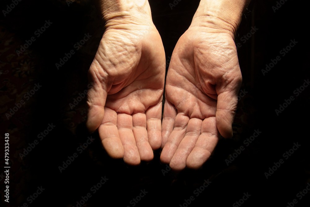 Two hands on a black background. The concept of asking for help. Stock ...