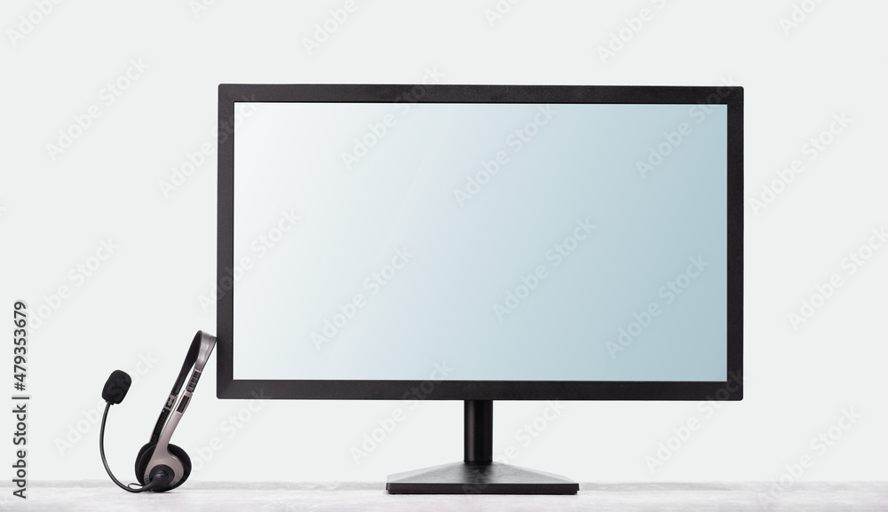 Computer monitor mockup for your design and VOIP headset on desk at ...