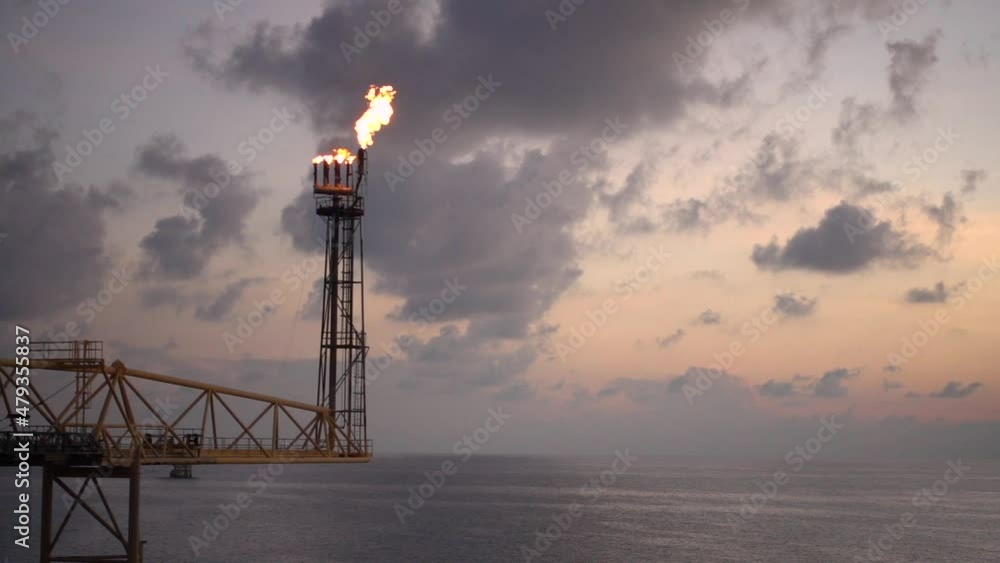 Slow motion of flare burning bridge of oil and gas platform or offshore ...