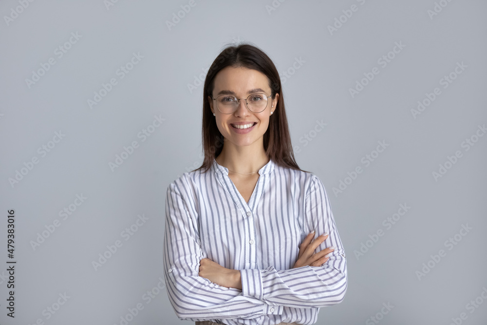 Happy millennial business woman in glasses posing with hands folded ...