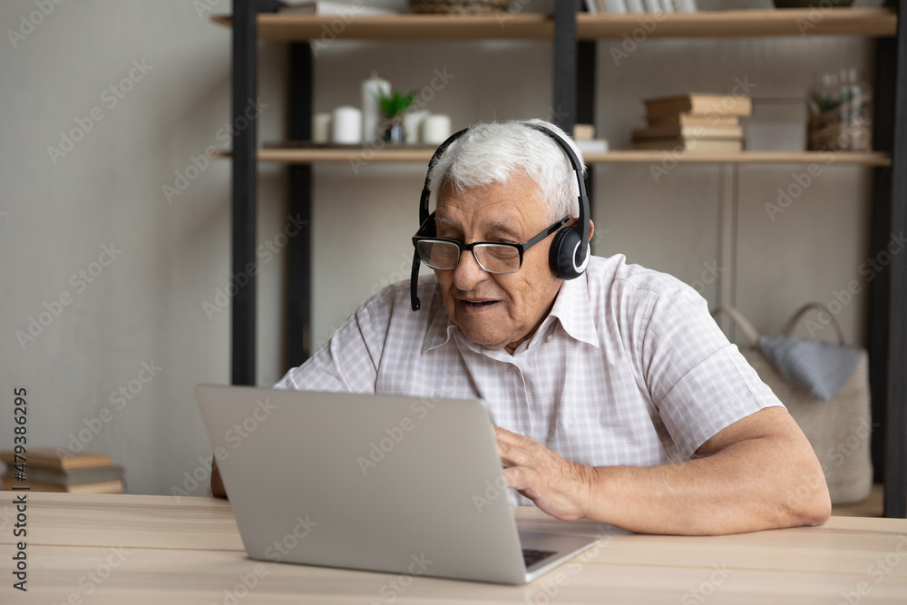Happy elderly senior male pensioner in headphones with microphone ...