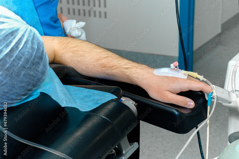 Anesthesia catheter in human hand during surgery. Selective focus ...