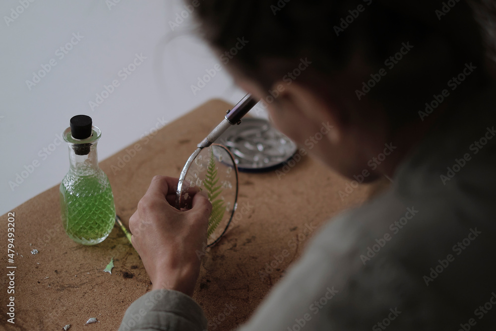 Stained glass maker works with colorful souvenirs. Female hands ...