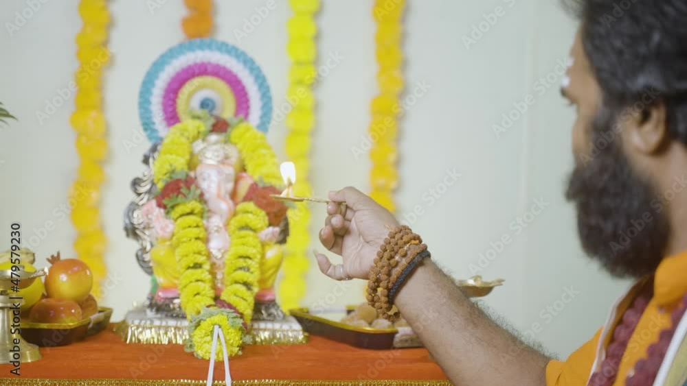 Focus on hand Holy god man or Indian priest offering aarti by chanting ...