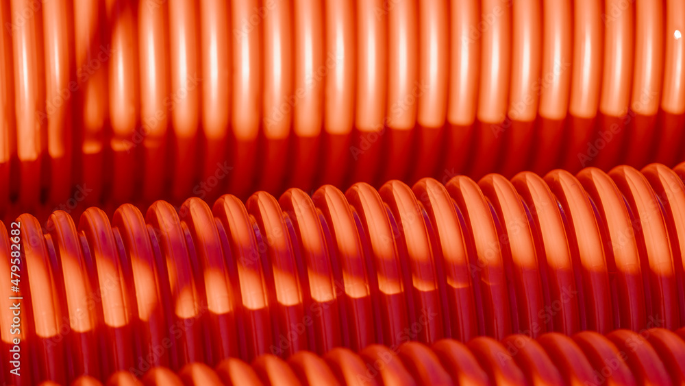 Red corrugated plastic tubes. Industrial background. Products from ...