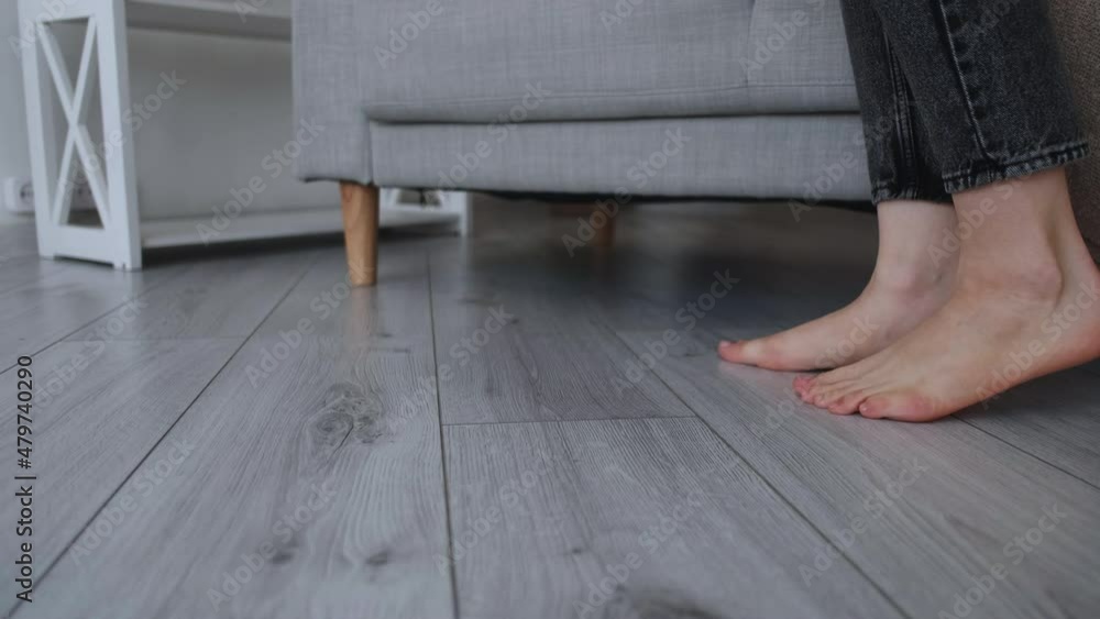 Heat floor. Female feet. Warming home system. Barefoot woman walking on ...