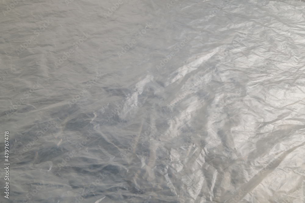 full frame background of flat crumpled semi-transparent polyethylene ...