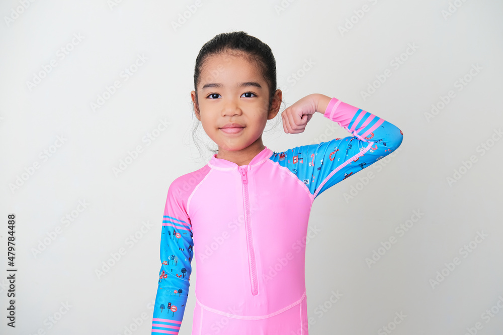 Asian little kid wearing swimwear showing her bicep muscle. Healthy ...