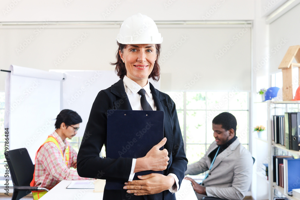 Confident beautiful middle aged engineer business woman in black suit ...