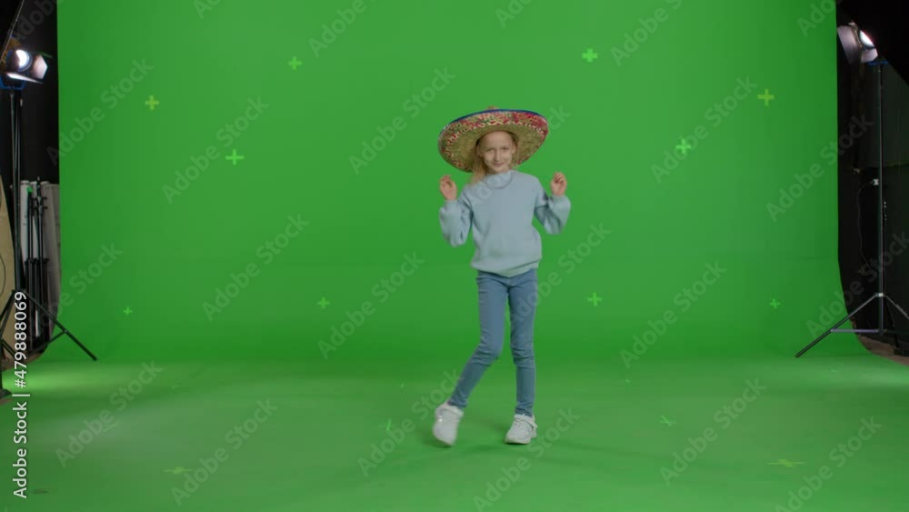 Lovely young Caucasian girl in sombrero dancing . Happy kid enjoying ...