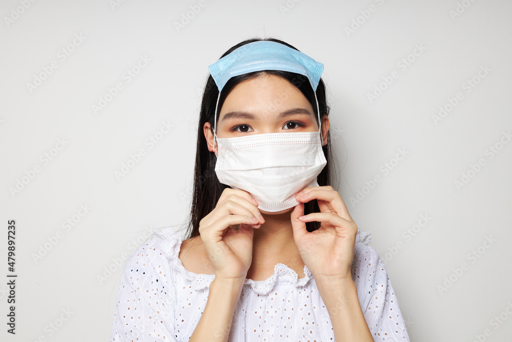 Charming young Asian woman two medical masks on the head protection ...