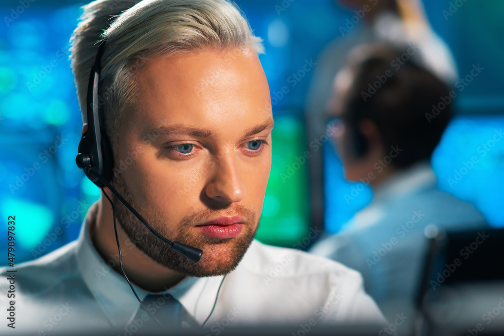 Aircraft flight control officer monitors the approach of aircraft from control tower. Air ...