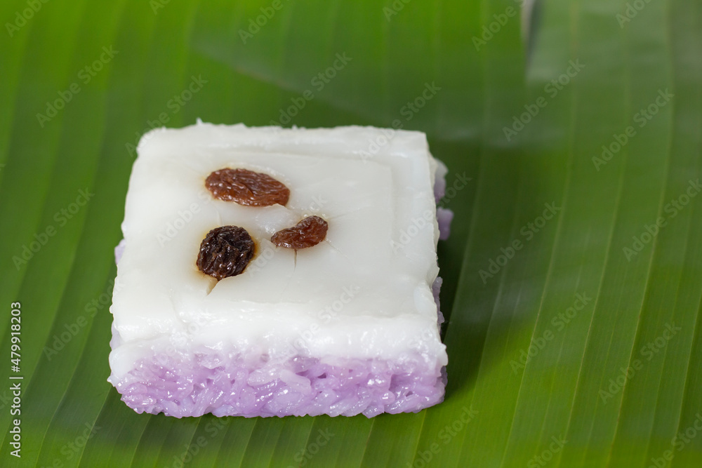 Thai sweet sticky rice cake with coconut milk and currant topping on ...