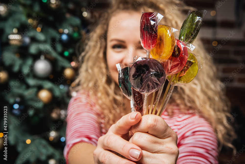 young pretty curly girl holding sweet lollipops, emotional, smiling ...