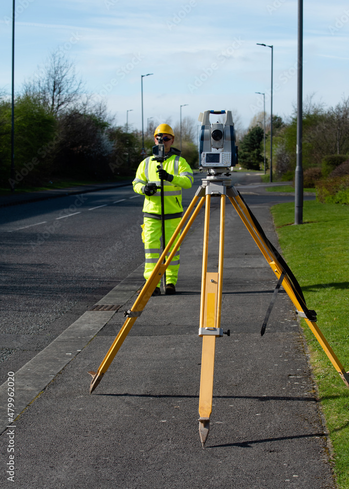 Surveyor doing road survey using modern robotic total station EDM ...