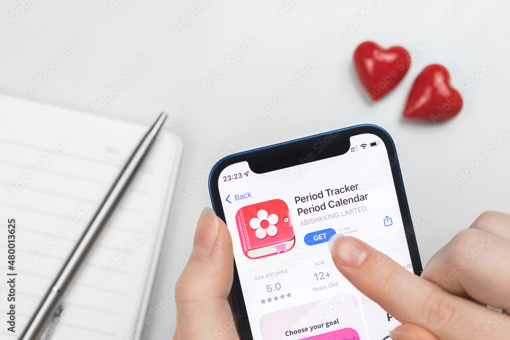 Period tracker and calendar app icon close-up. Woman uses the ...