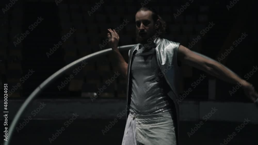 A circus performer spins Sir's wheel around him in the arena. The large ...