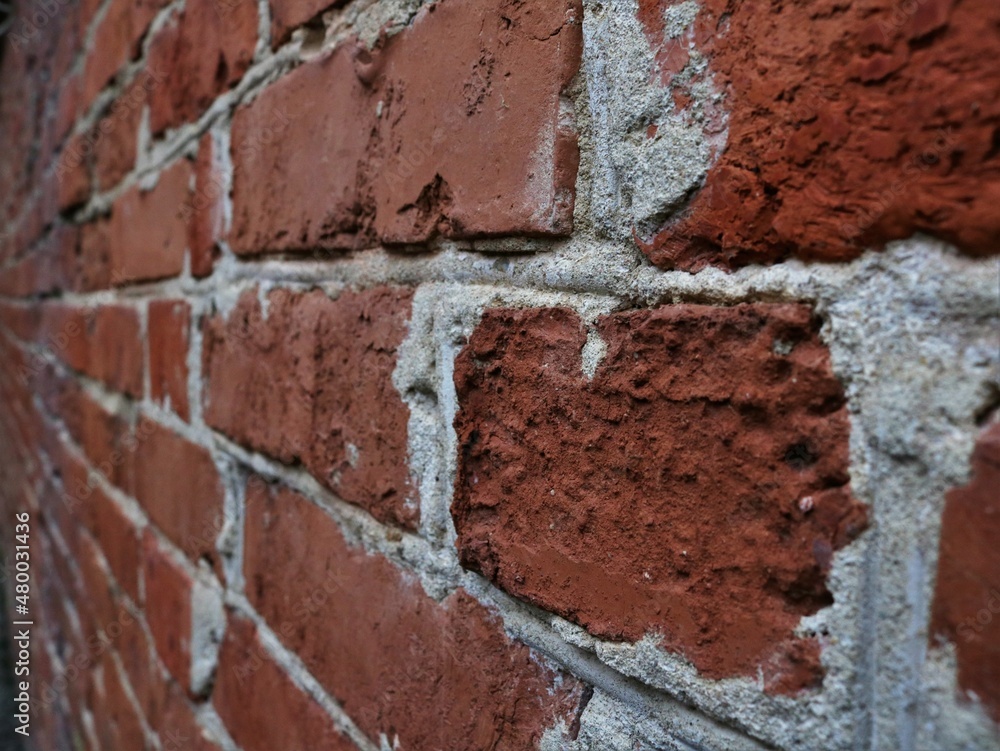 blurred brick wall perspective in detail, textured brickwork from close ...
