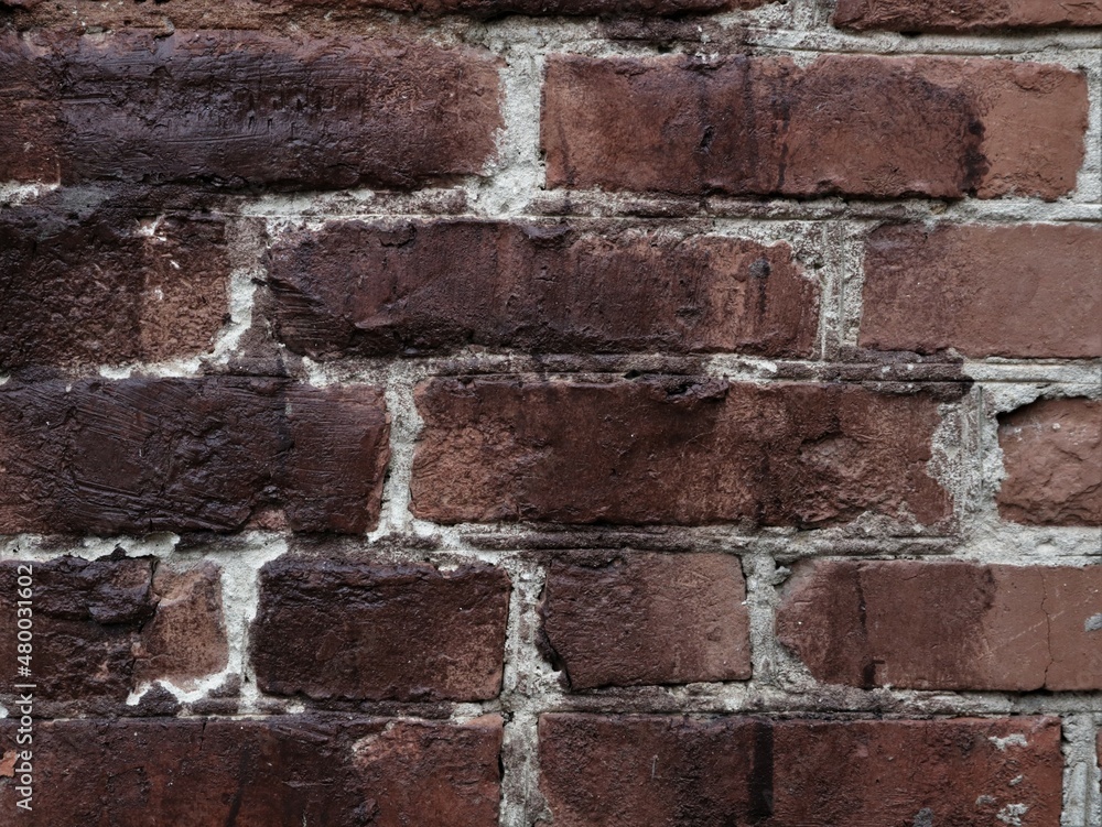 brick background with brown blocks and dark burnt coating close-up ...