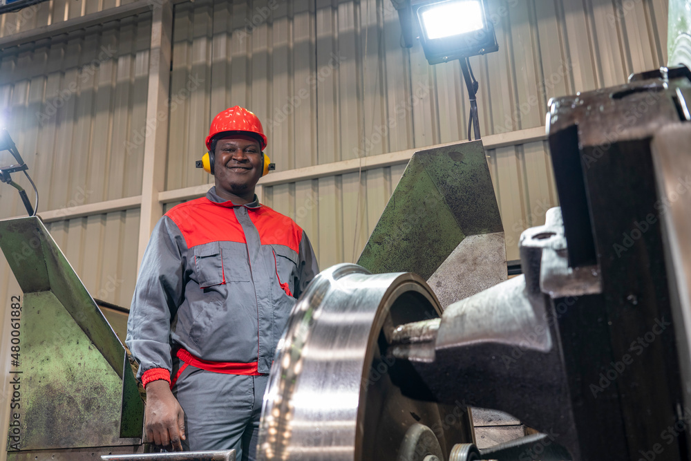 Smiling African American CNC Machine Operator Monitoring The Train ...