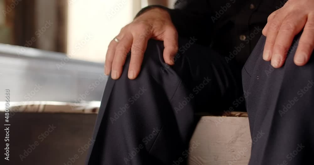 Thrilled old man sits on the bed and puts his hands to his knees, 4k ...