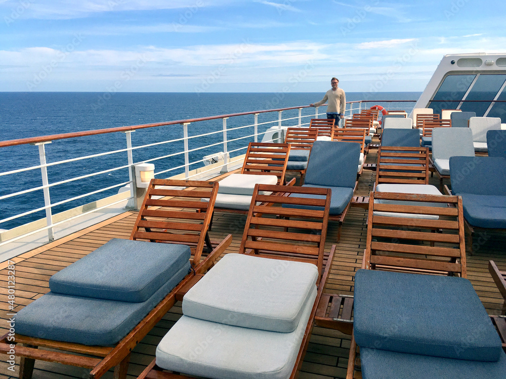 Passengers enjoying open outdoor promenade sun decks of legendary ocean ...