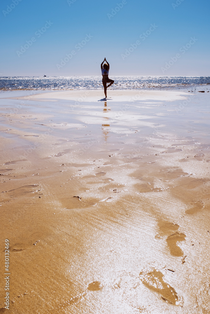 Yoga balanced posture for woman in silhouette standing at the beach ...