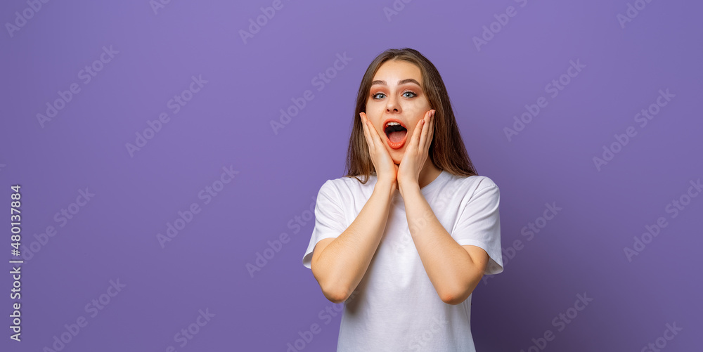 Shocked and surprised girl holding hands on face, open mouth, hear ...
