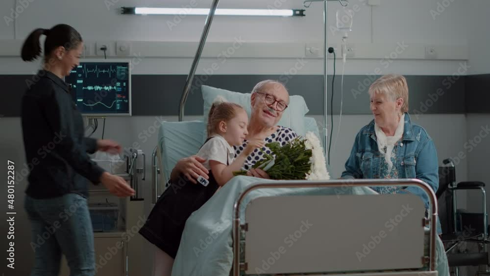 Child and daughter of sick patient coming to visit in hospital ward ...