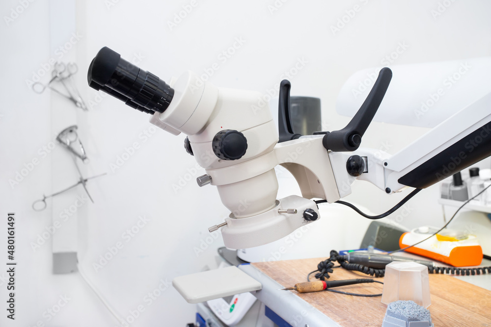Microscope in a dental laboratory, a technician's workplace in a dental ...