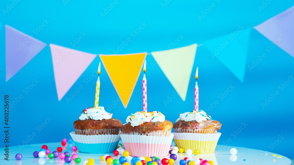 Beautiful background with cream cupcakes and lit candles, festive ...