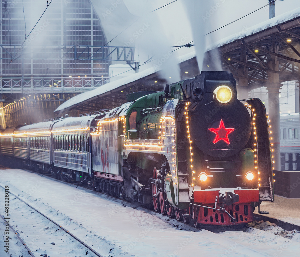Steam retro train stands by the platform. Stock Photo | Adobe Stock