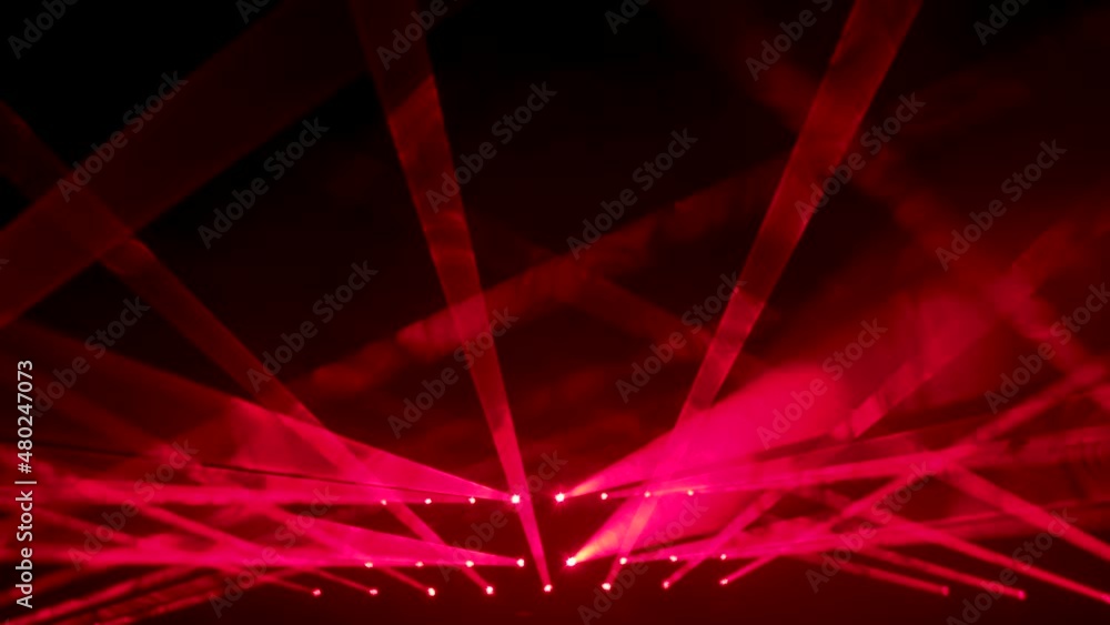 Colorful beams of red stage light in smoky dark studio. Red spotlights ...