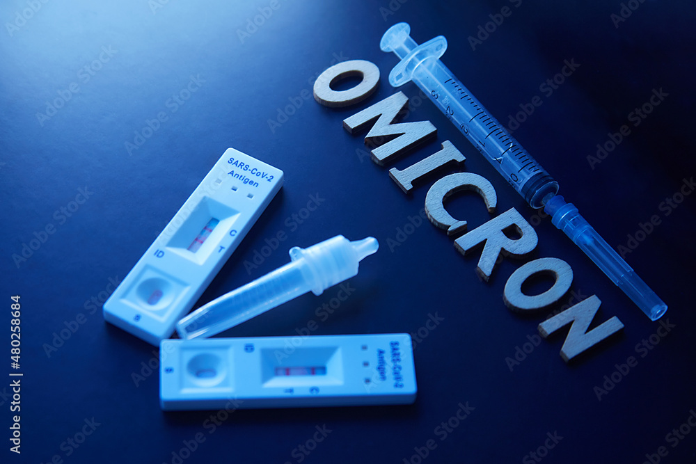 word omicron made from wooden letters,syringe, medical injection bottle ...
