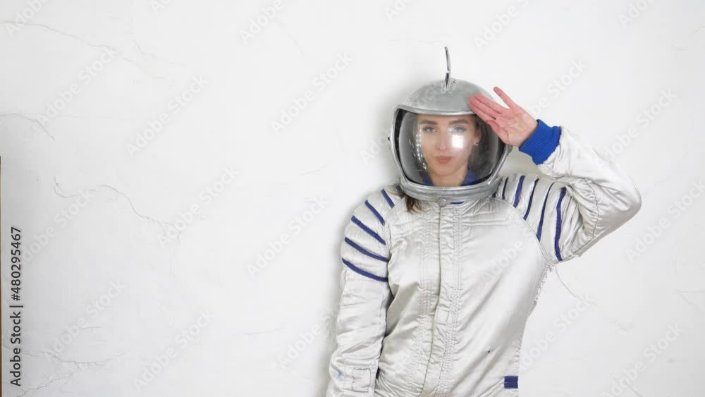 girl in a space suit and a fantastic helmet on the background of a ...